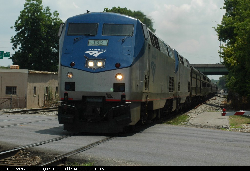 AMTK 133 puliing across grade crossing